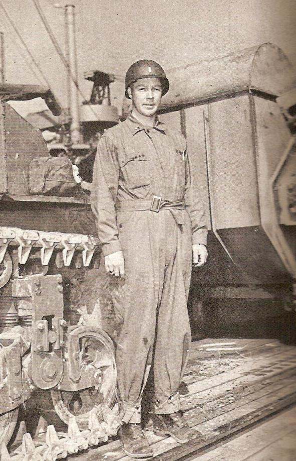 Photo of a tank officer standing next to tanks loaded on a ship WWII ...