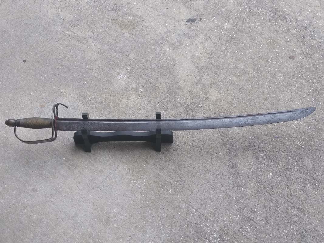 Can anyone identify this Sword engraving? Flags with G W crown ...